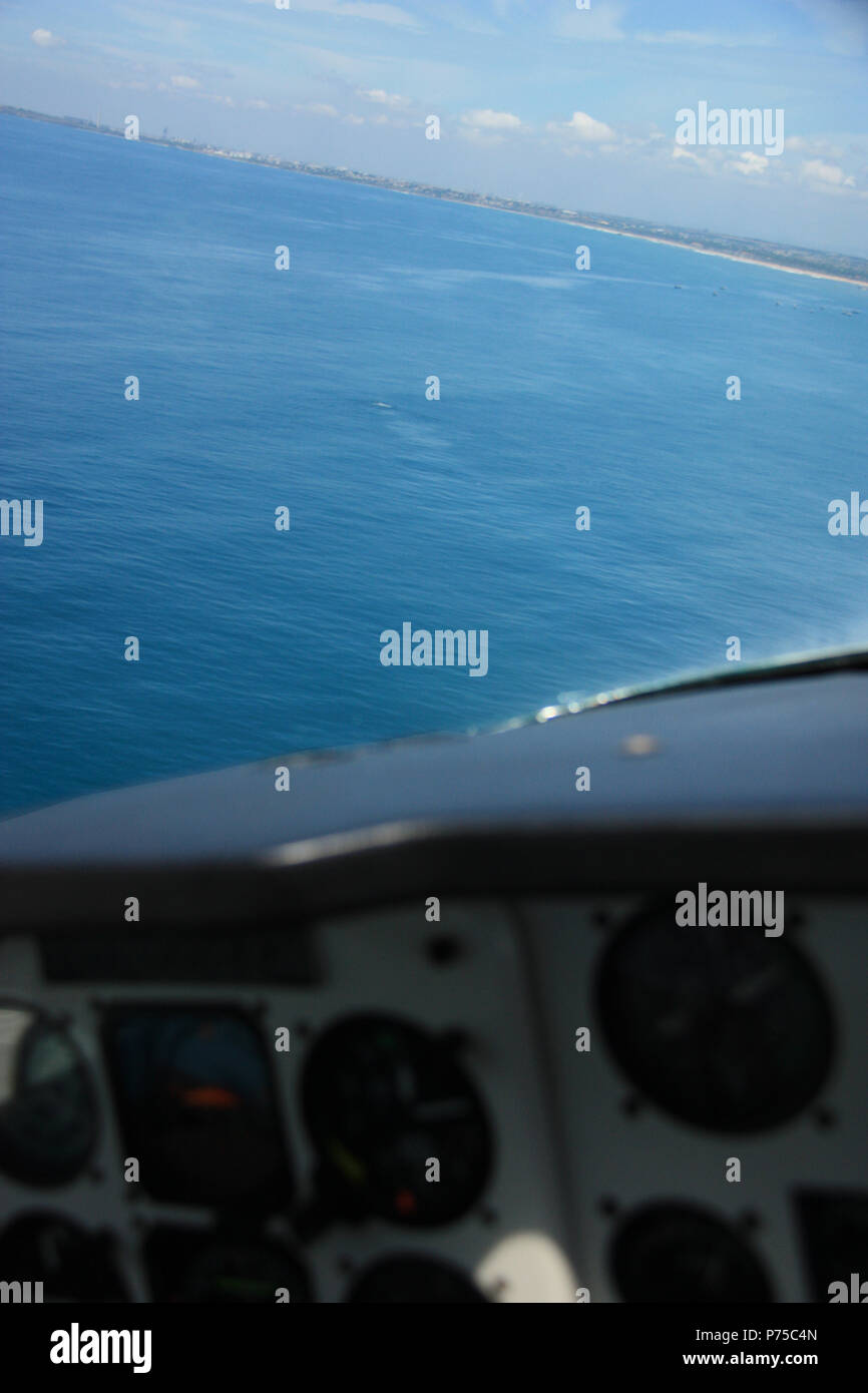 Fishing boats and a humpback whale off the shore of ghana, as seen from ...