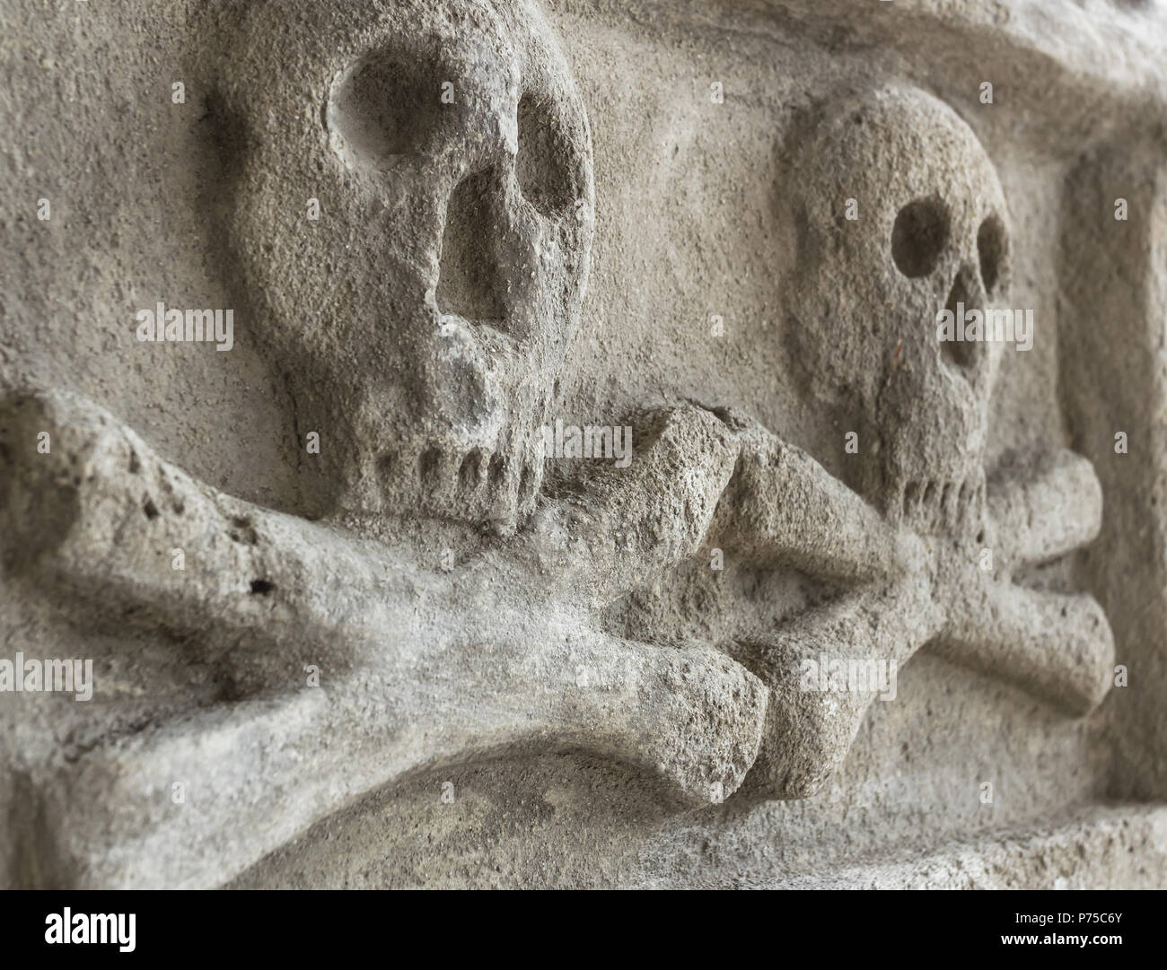 Ancient stone skull with crossbones. Old sculpture. Ideal for concepts ...