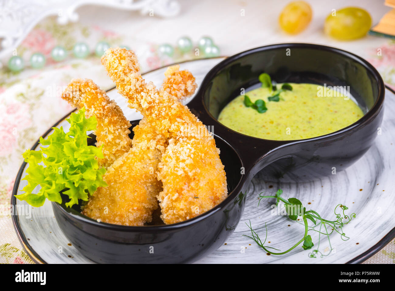 Fried frog legs on plate with lemon sauce food concept Stock Photo - Alamy