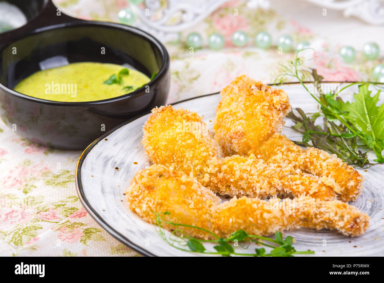 Fried frog legs on plate with lemon sauce food concept Stock Photo - Alamy