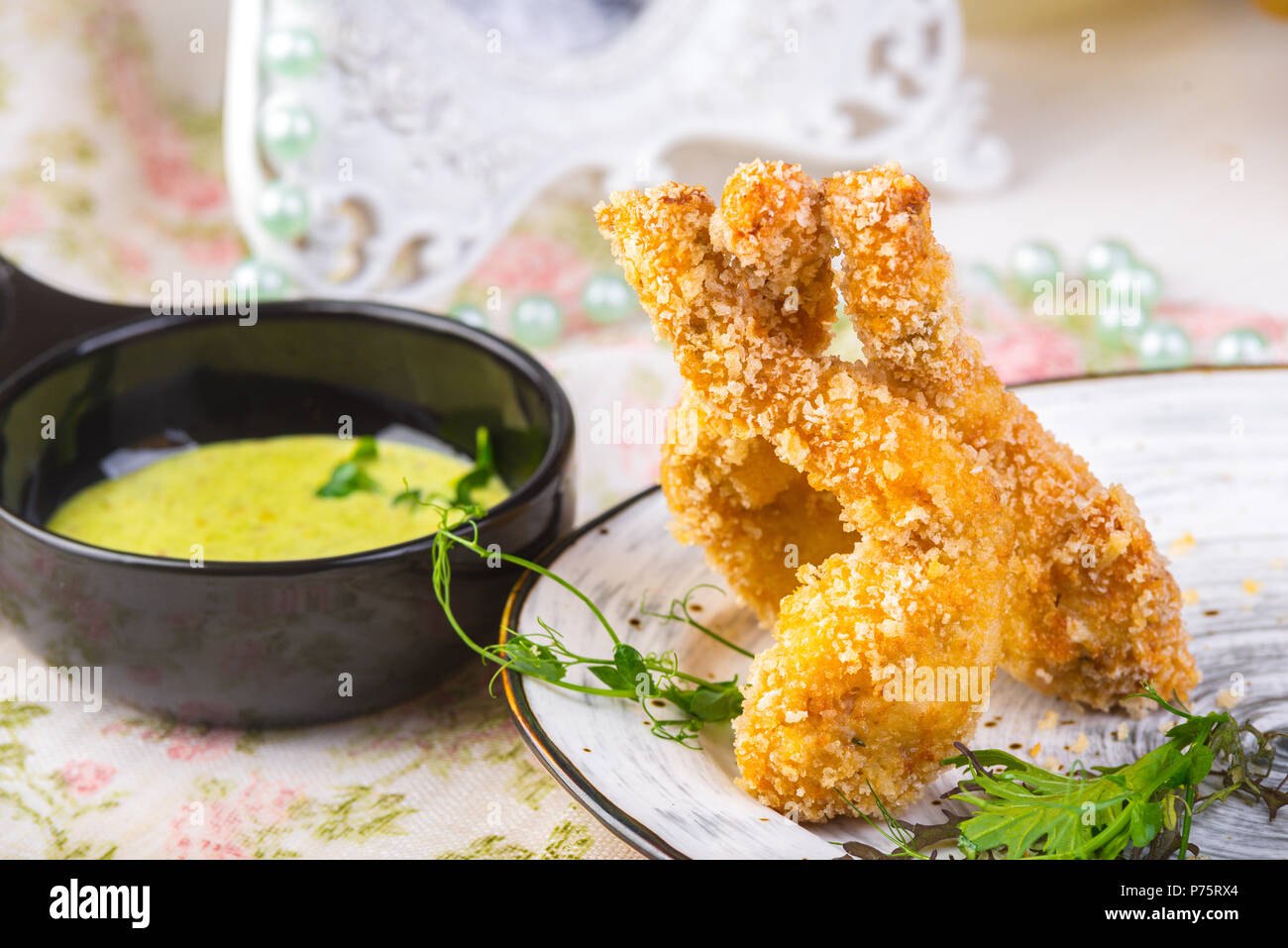 Fried frog legs on plate with lemon sauce food concept Stock Photo - Alamy