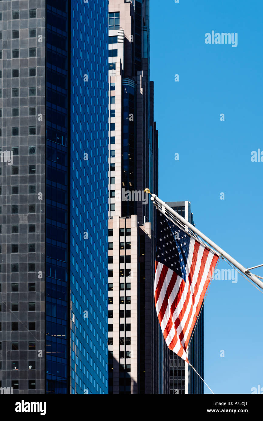 American flag waving against modern office building Stock Photo - Alamy