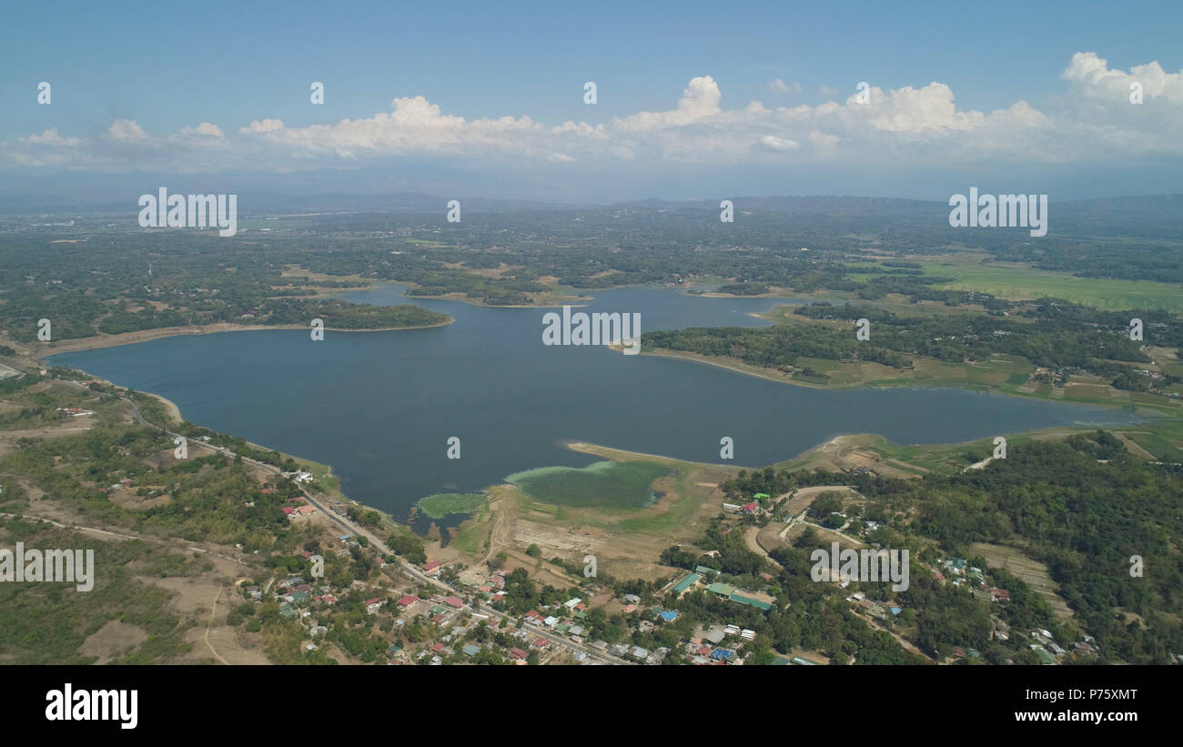 Aerial view of Paoay lake against background of mountains and sky with ...