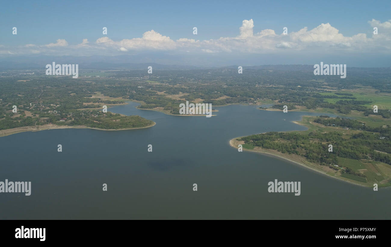 Aerial view of Paoay lake against background of mountains and sky with ...