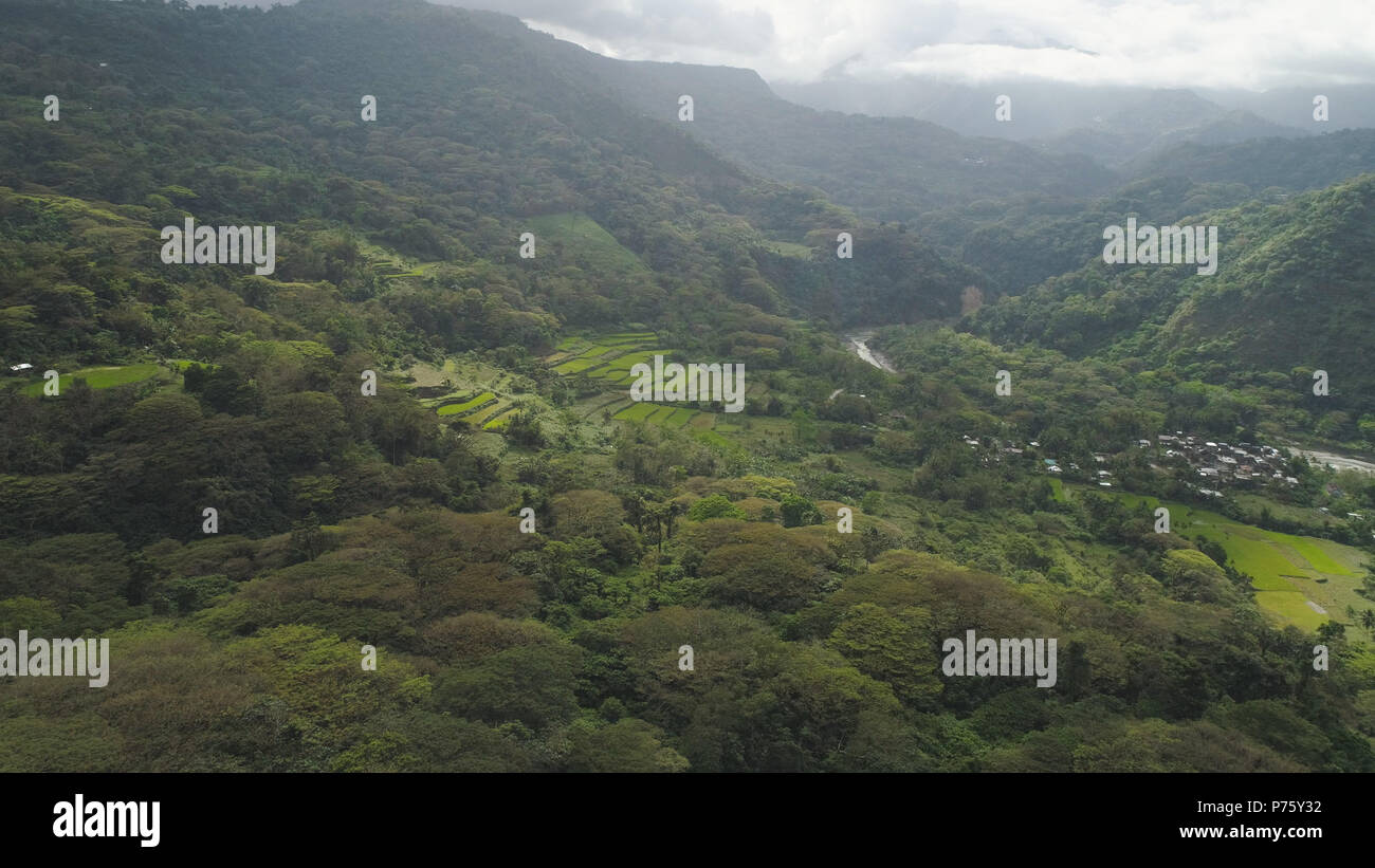 Aerial view of mountain valley with river, rice terraces, farmland in ...