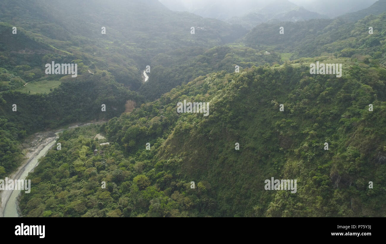 Aerial view of mountain valley with river, rice terraces, farmland in ...