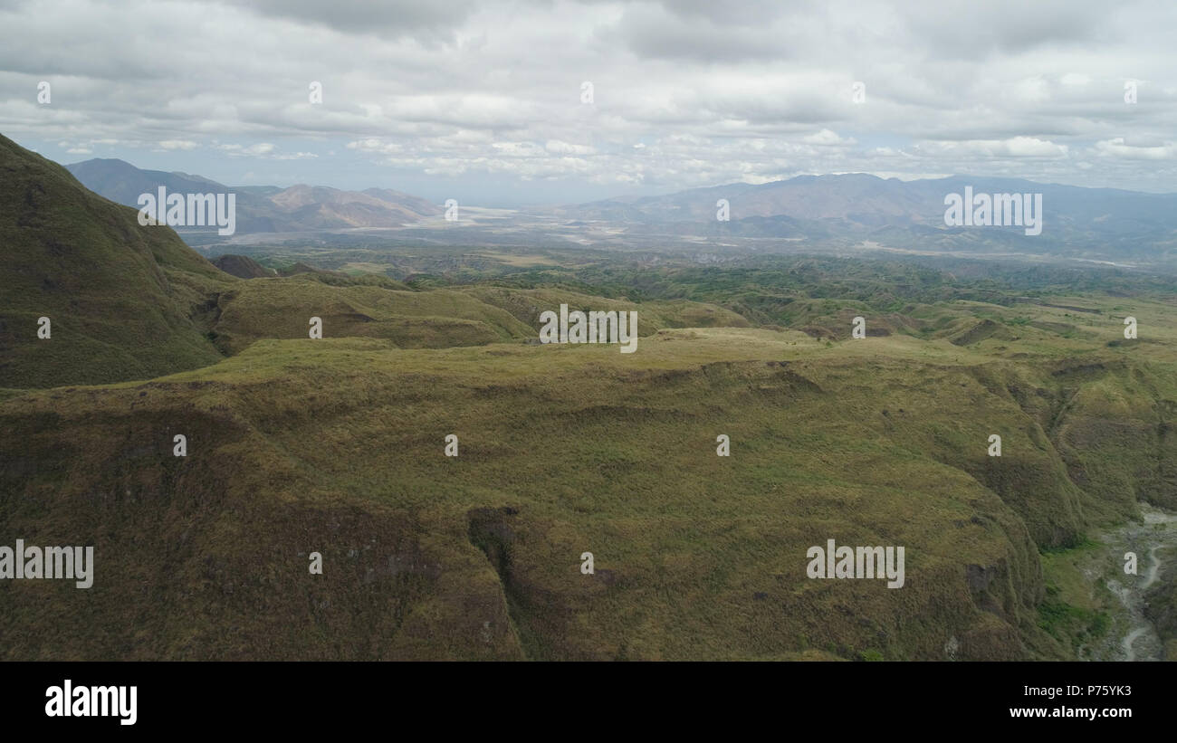Aerial view of mountains covered with green vegetation, trees in ...