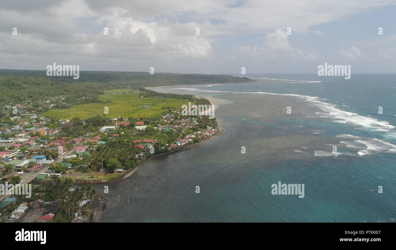 Aerial view of seashore with coastal town, beach, lagoons and coral ...