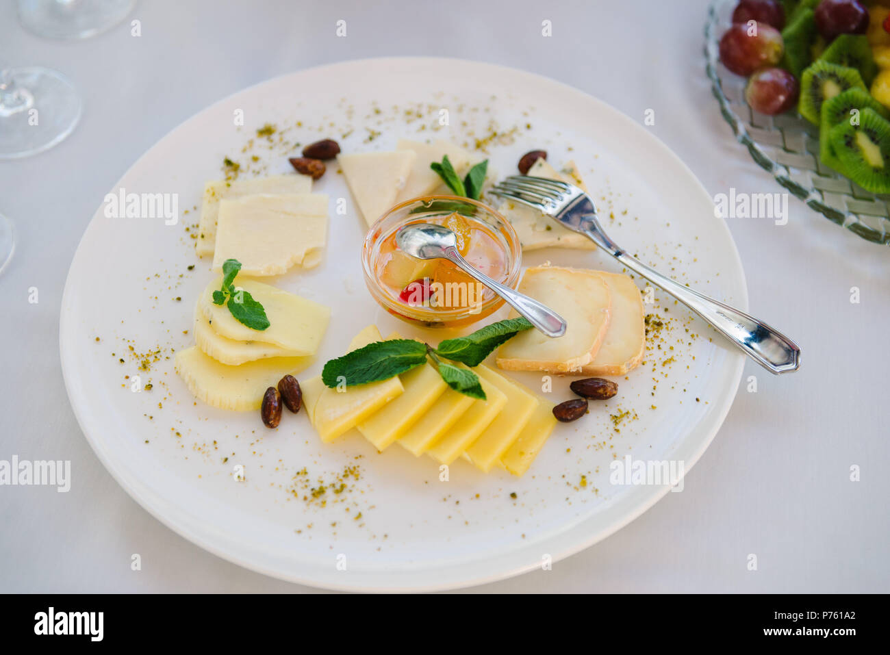 Hard tasty cheese on a plate. Festive snack Stock Photo - Alamy
