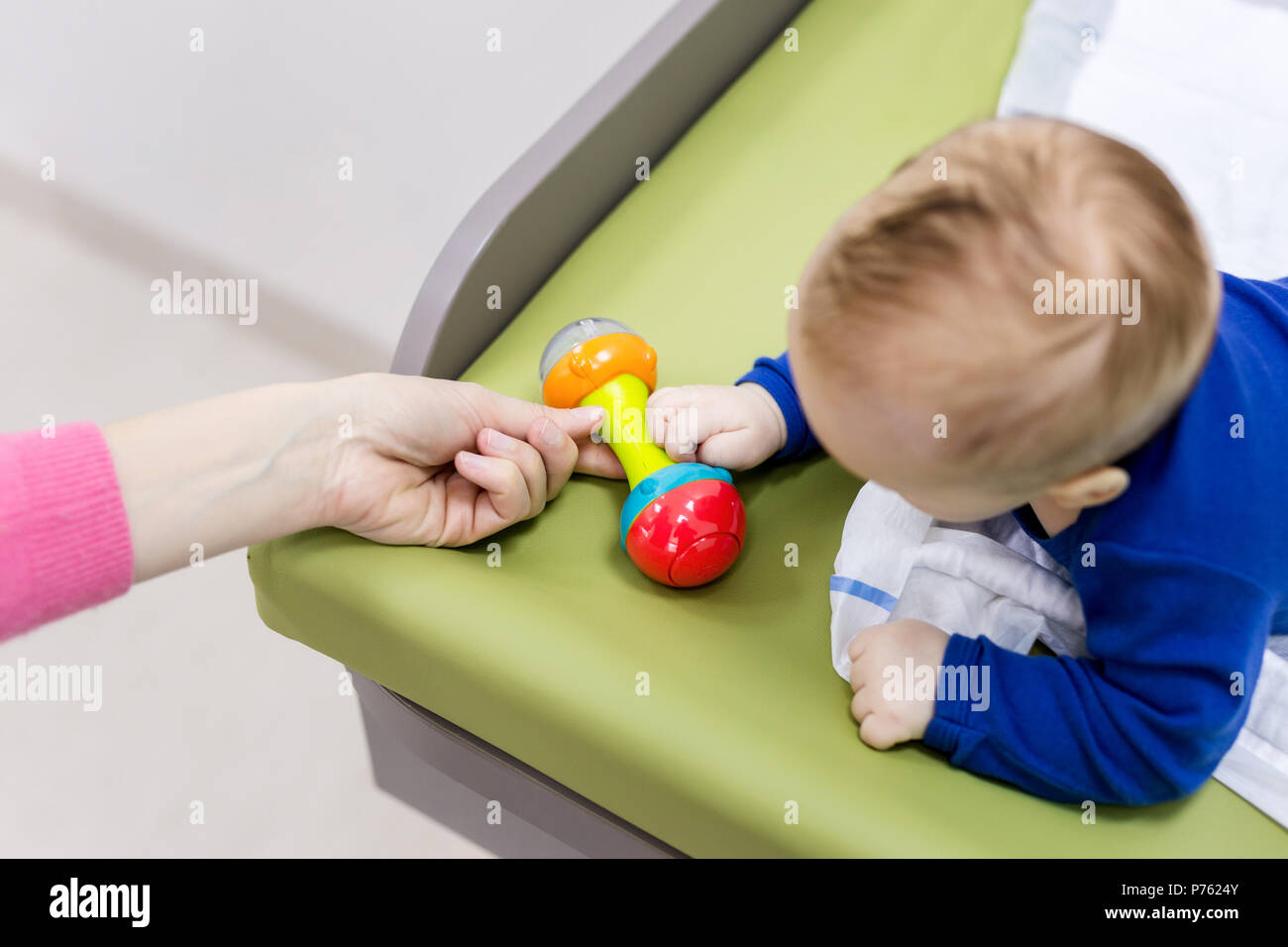 Baby boy holding rattle hi-res stock photography and images - Alamy