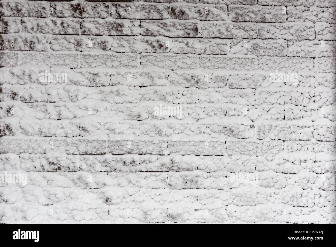 Brick wall covered with snow. Iced winter surface texture. Copyspace ...
