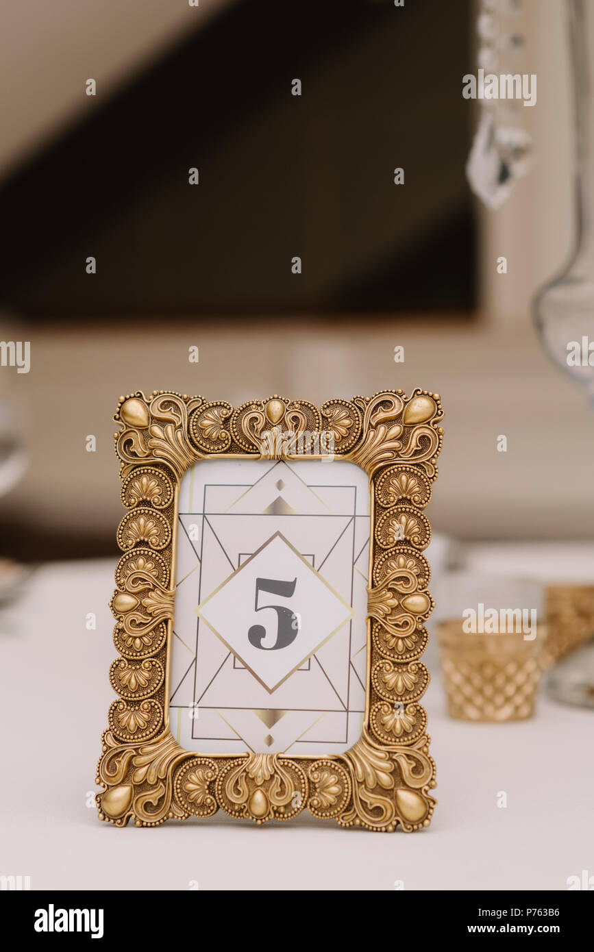 Wedding decor with table number in golden frame. Number Five Stock ...