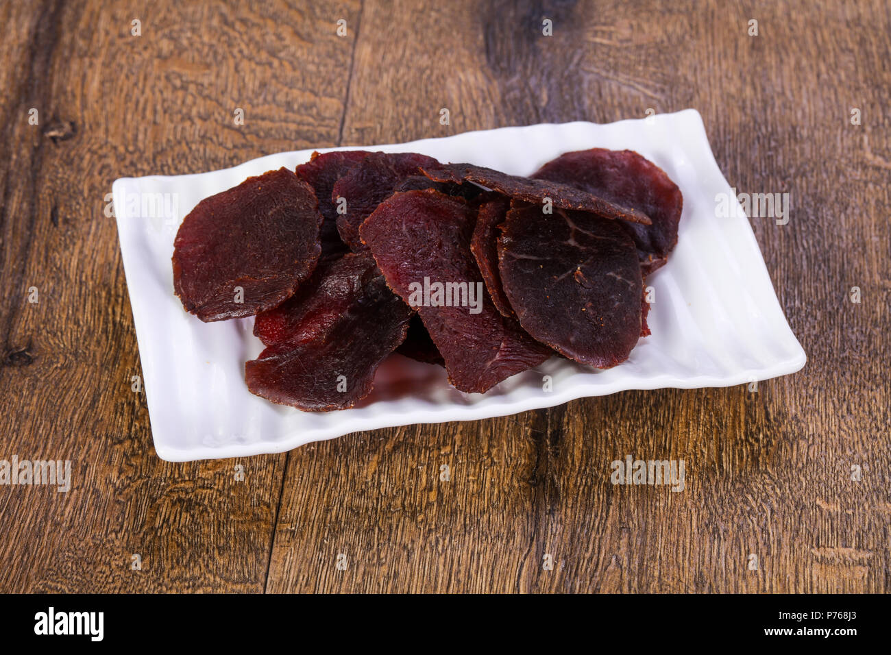 Dry beef meat over wooden Stock Photo - Alamy