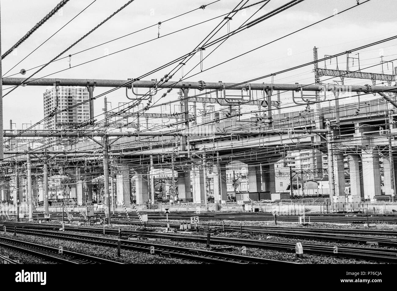 A mass of overhead electricity wires at a train station, Omiya, Japan ...
