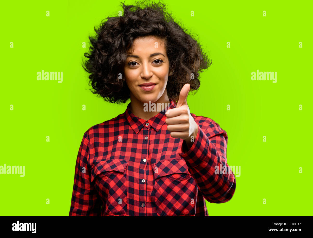 Beautiful arab woman smiling broadly showing thumbs up gesture to ...