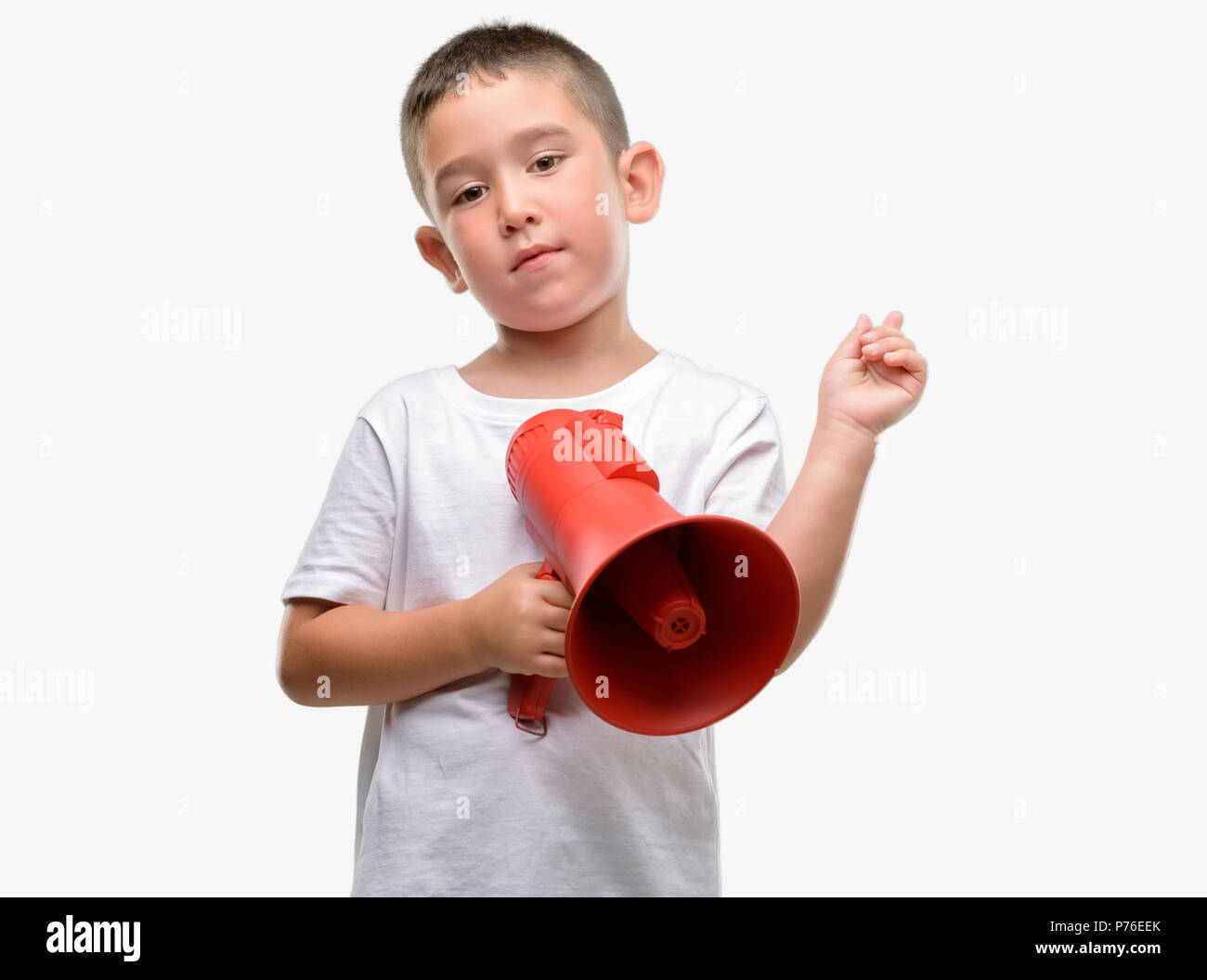 Dark haired little child holding megaphone very happy pointing with ...
