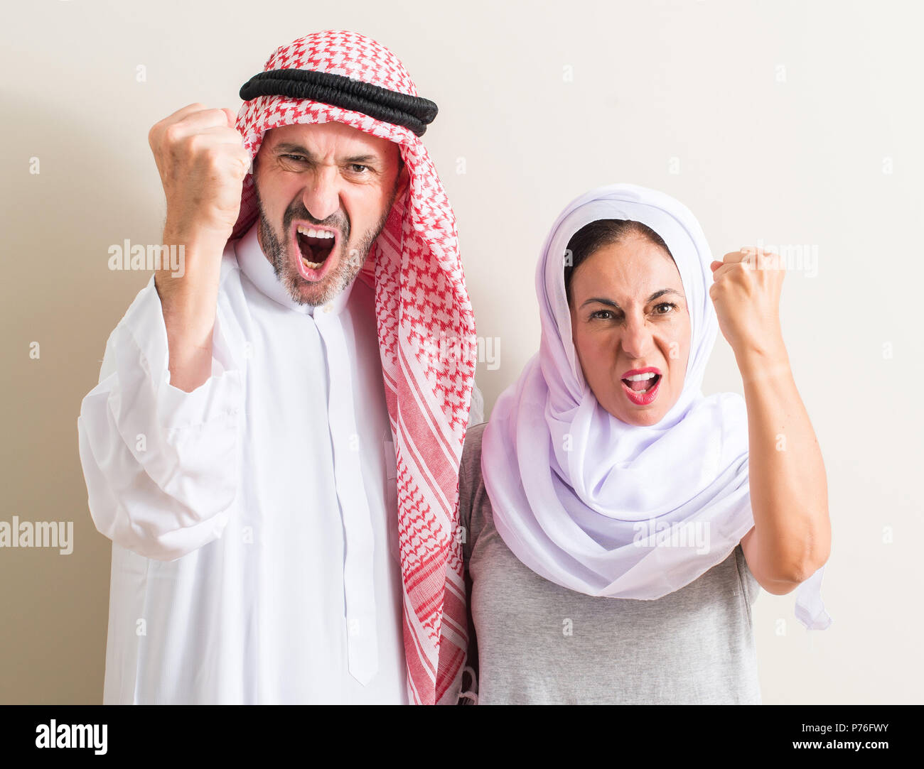Middle age arabic couple, woman and man annoyed and frustrated shouting ...