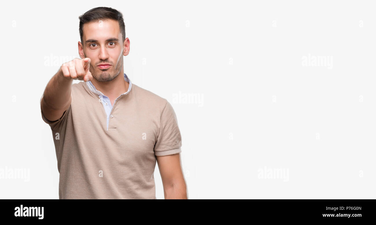 Handsome young man pointing with finger to the camera and to you, hand ...