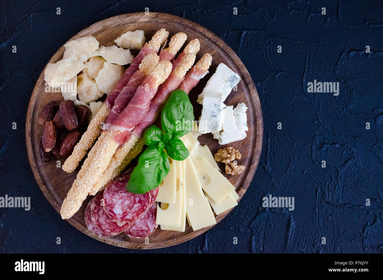 Wooden board full of mediterranean appetizers, tapas or antipasti ...