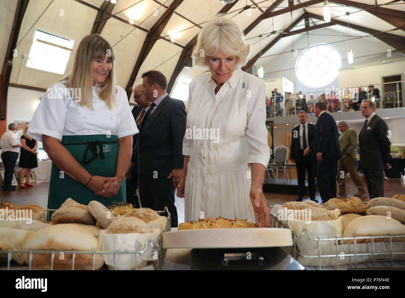 The Duchess of Cornwall looks at produce during the reopening of the ...