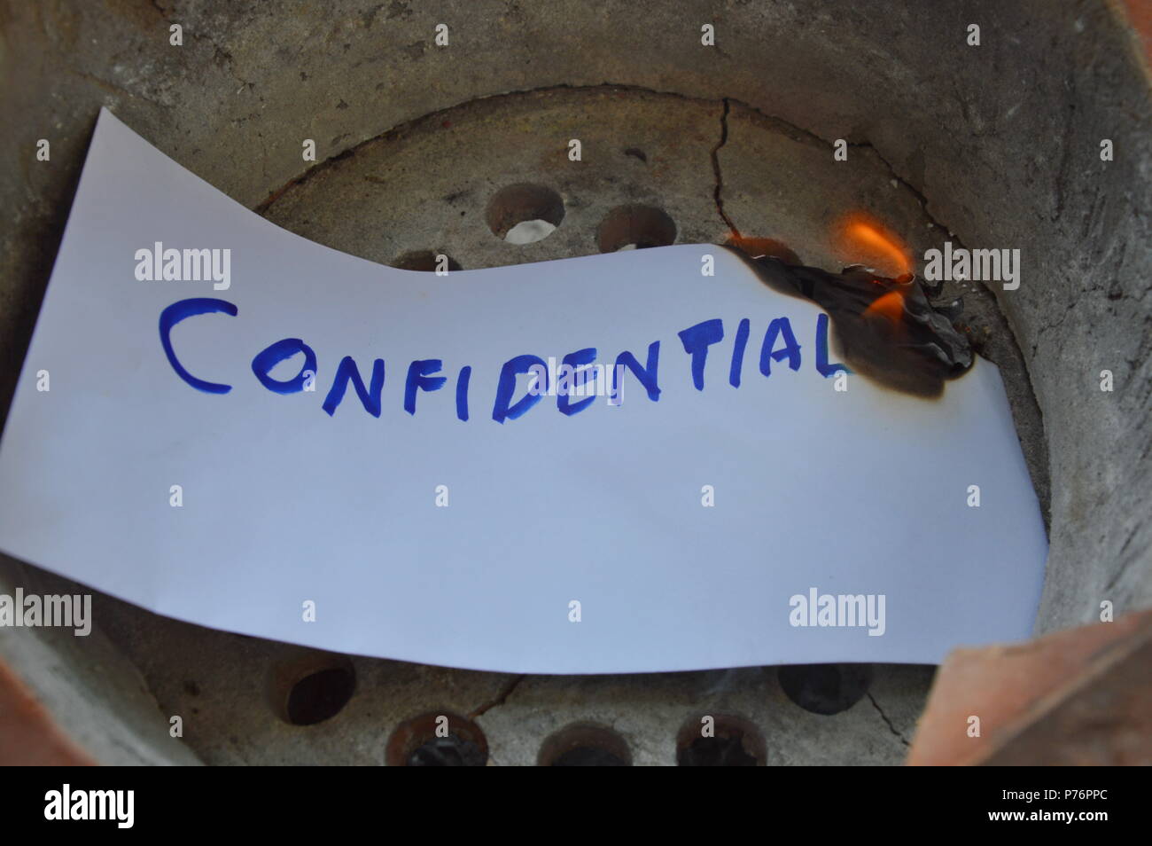 envelope burn on clay stove Stock Photo - Alamy