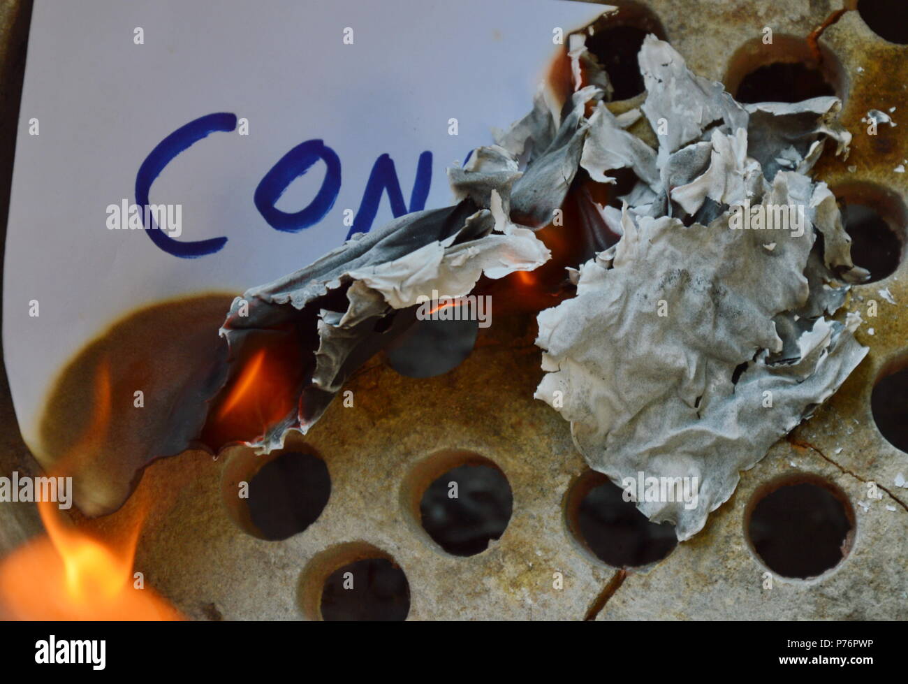 envelope burn on clay stove Stock Photo - Alamy