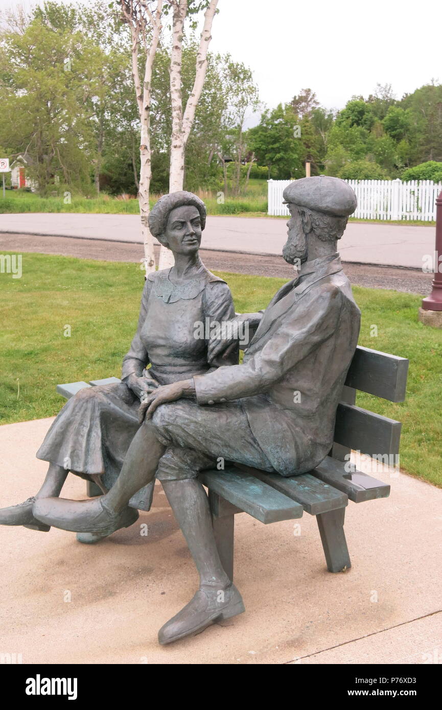 Statue of a seated couple on a bench at Baddeck seafront to commemorate ...
