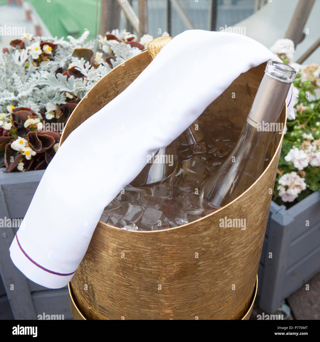 A bottle of soda water in a brass pail for ice cooling Stock Photo - Alamy