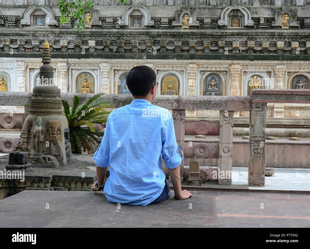 An Asian man practicing yoga meditation at a monastery Stock Photo - Alamy