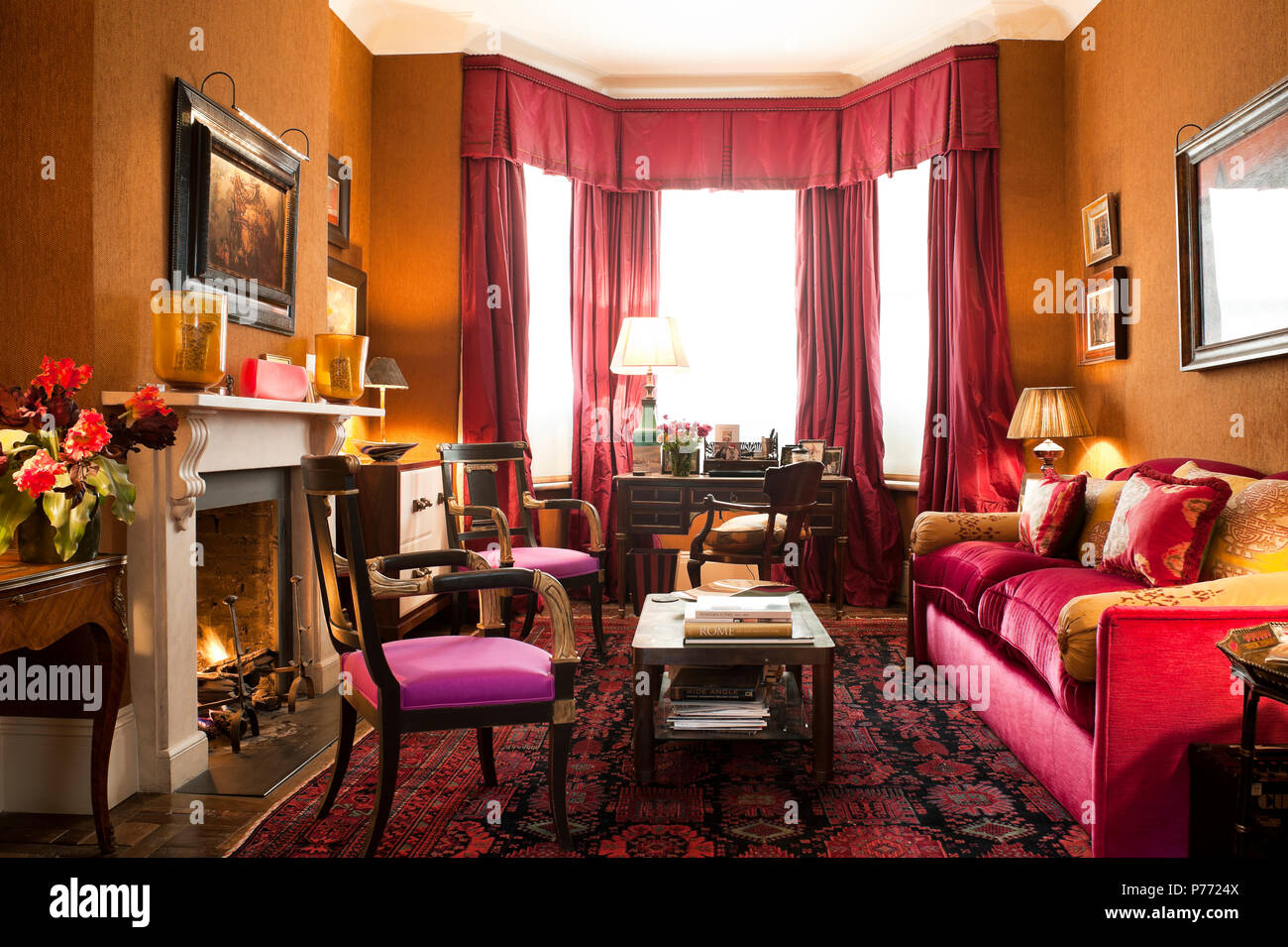 Lit fire in cosy living room Stock Photo - Alamy