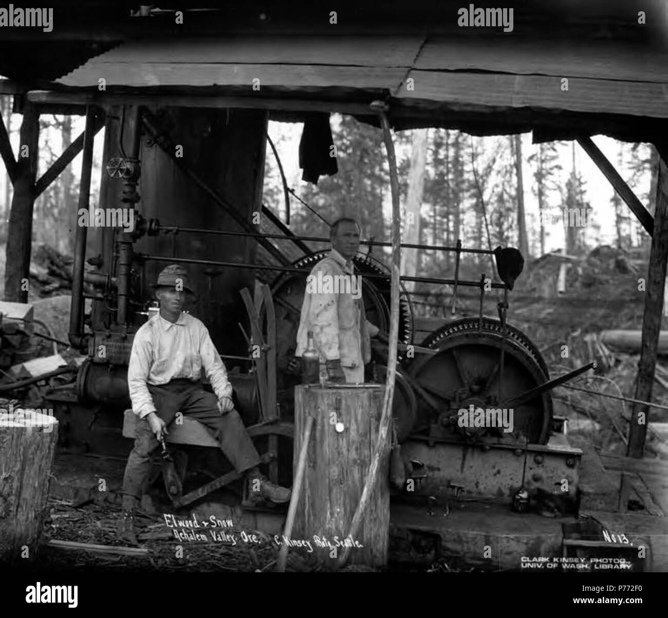 . English: Closeup of two men with donkey engine, Elwood and Snow ...