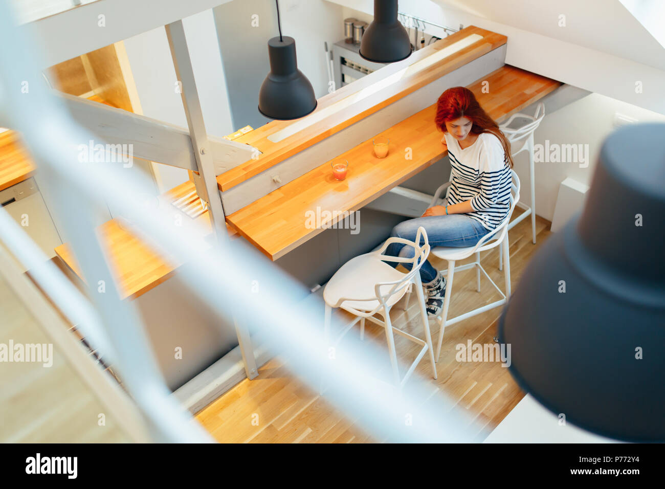 Woman sitting on kitchen counter hi-res stock photography and images ...