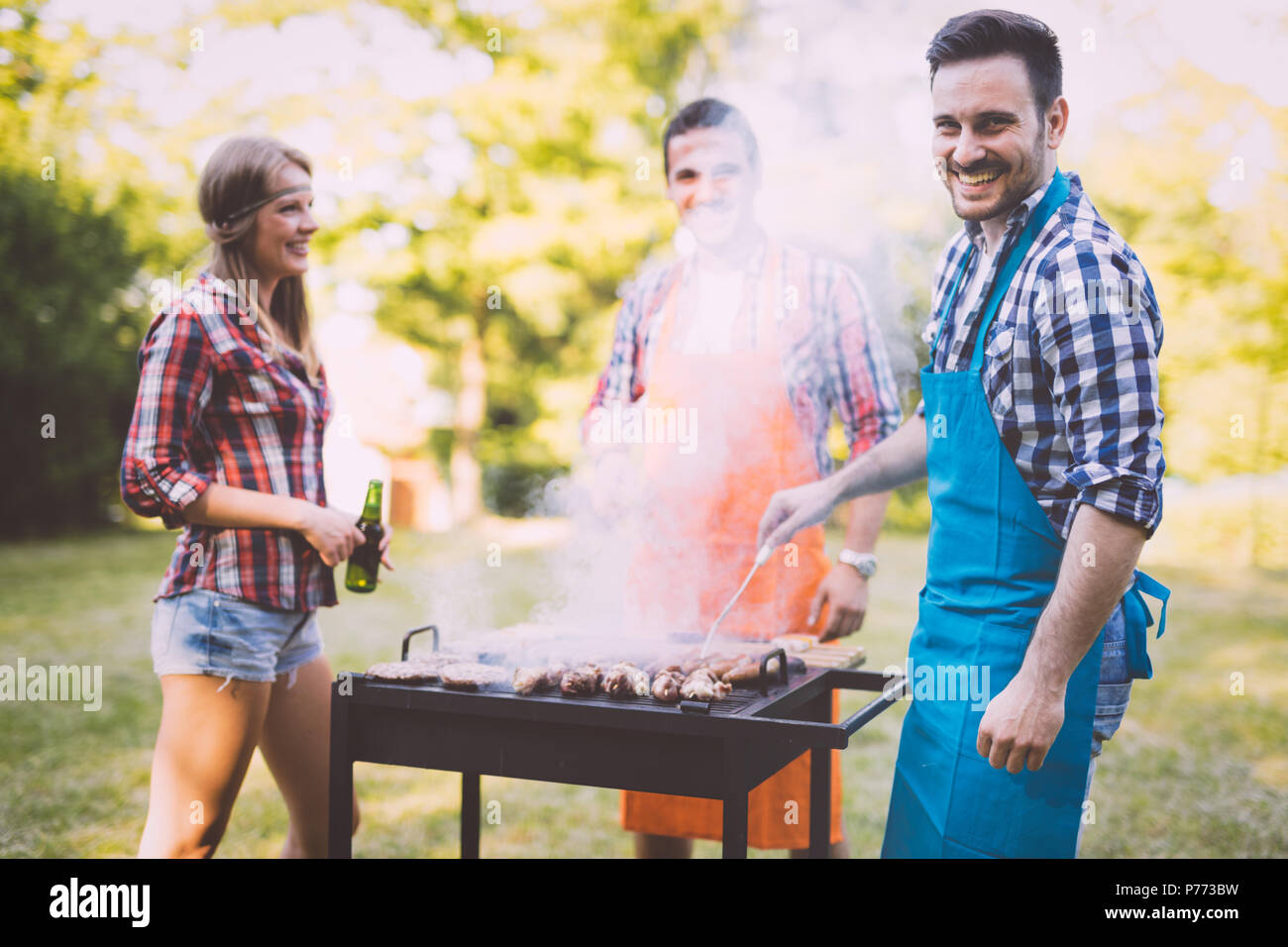 Friends having a barbecue party in nature Stock Photo - Alamy