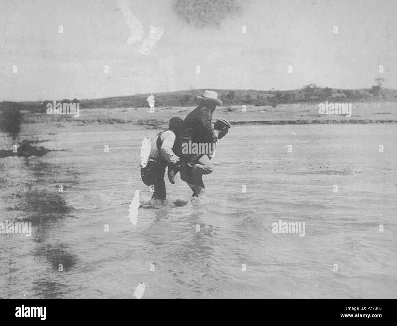 . English: Japanese men carrying Mr. Ragsdale across river, Amur River ...
