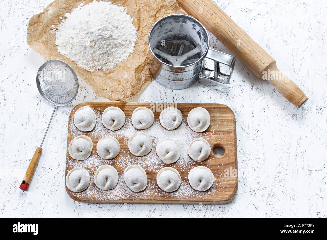 The process of making home-made dumplings. Raw homemade dumplings on a ...