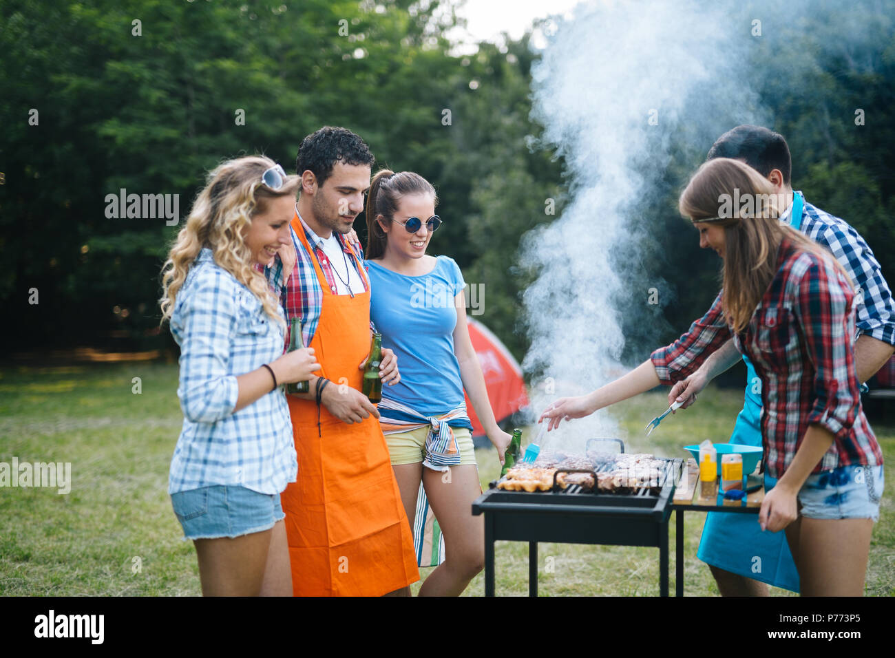 Happy friends enjoying barbecue party Stock Photo - Alamy