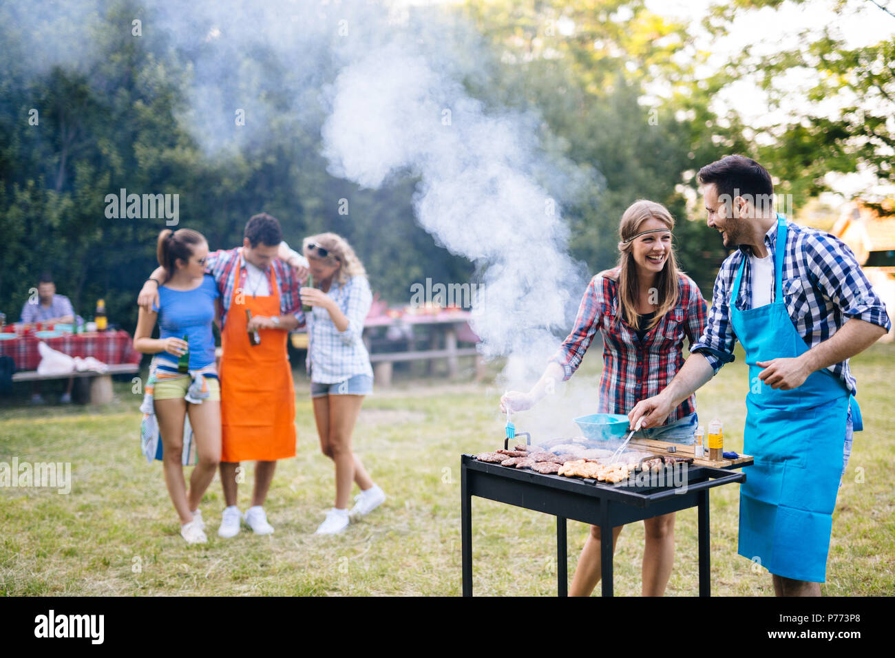 Happy friends enjoying barbecue party Stock Photo - Alamy
