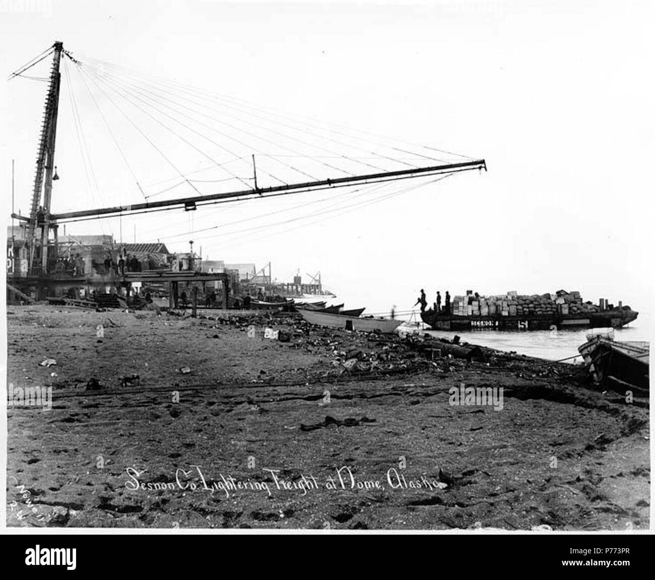English: Lightering company unloading freight from a scow on the beach ...
