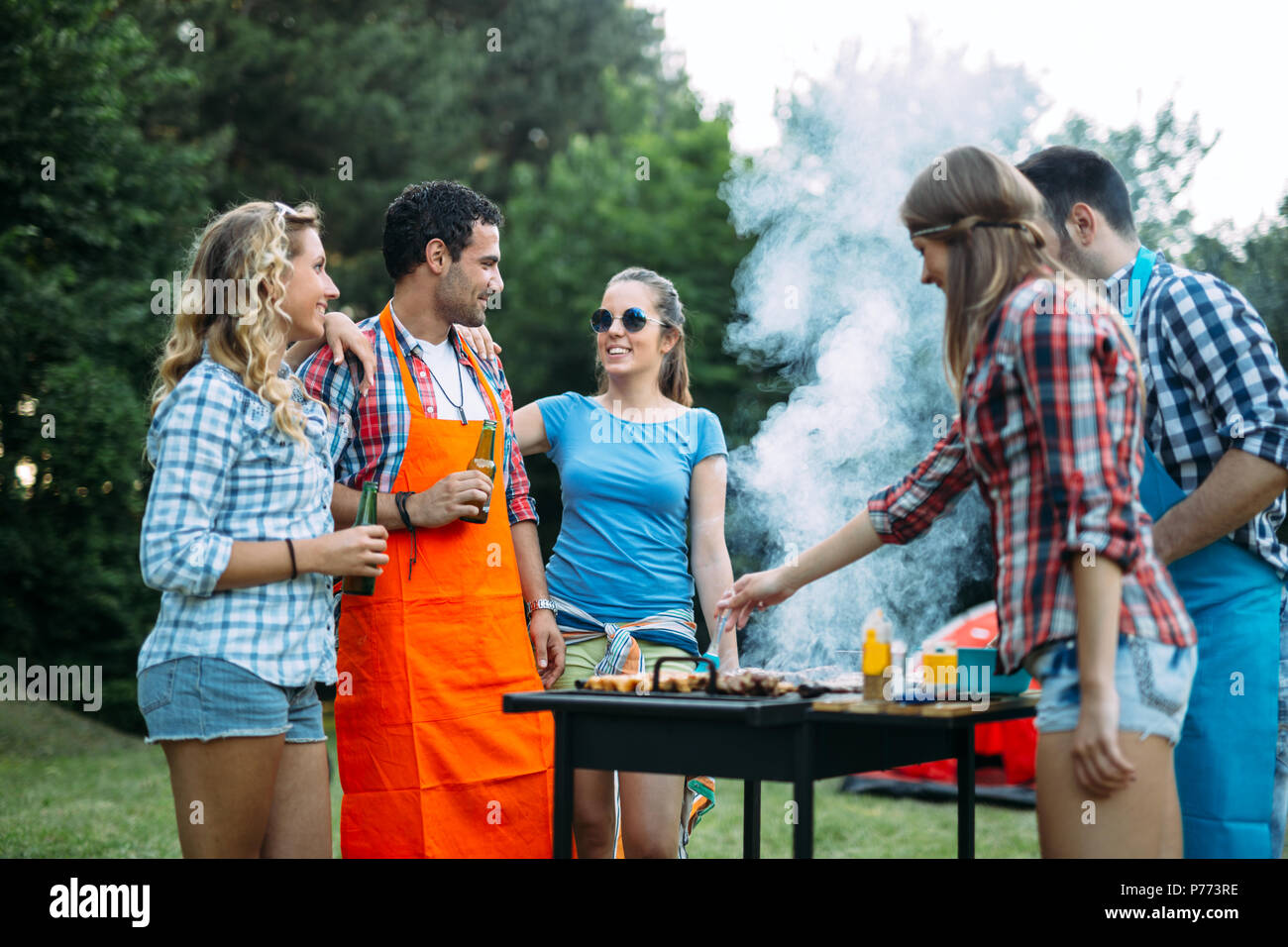 Happy friends enjoying barbecue party Stock Photo - Alamy