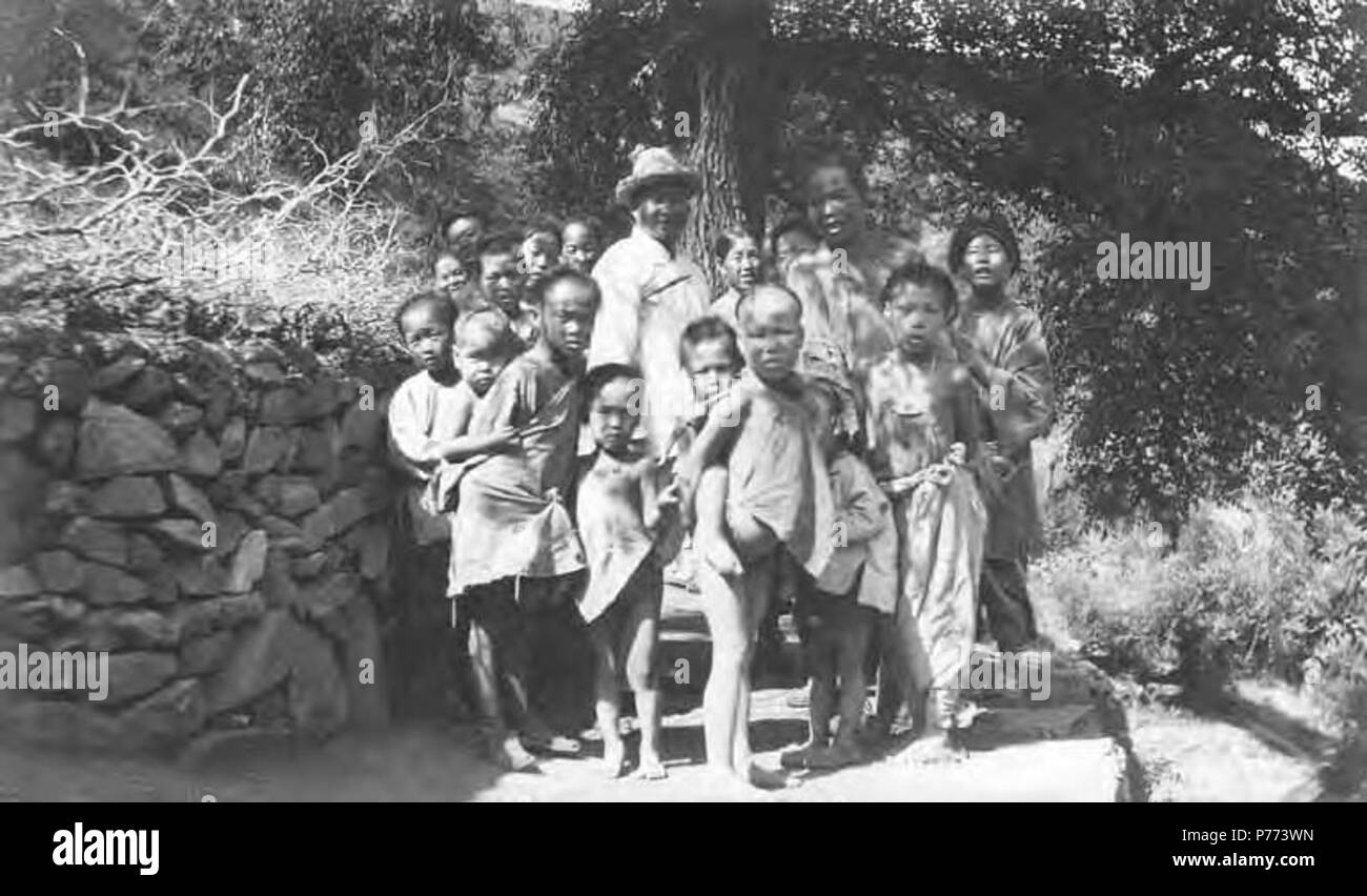 . English: Local man with group of children, ca. 1905 . English ...