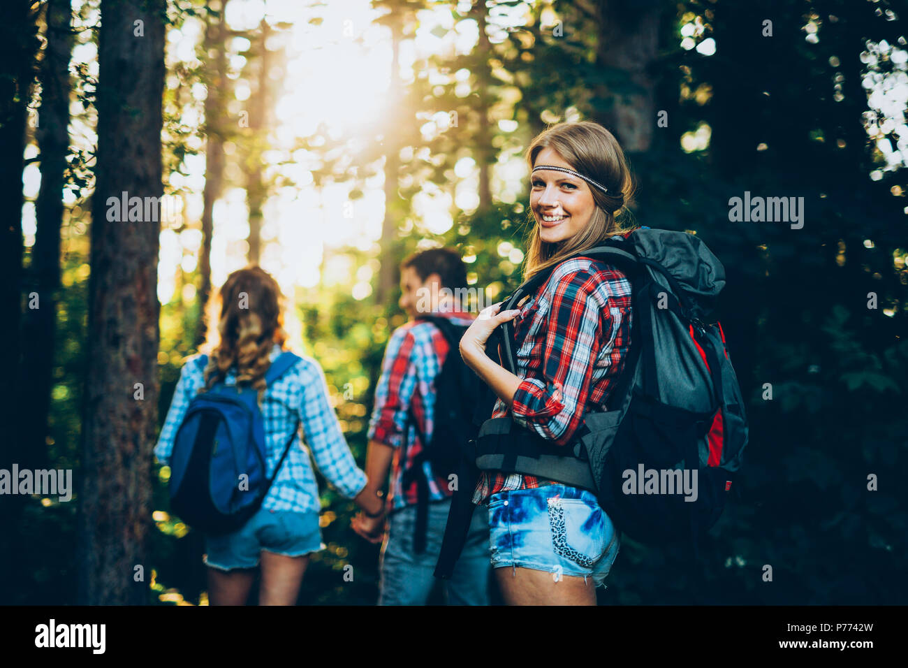 Group of backpacking hikers going for forest trekking Stock Photo - Alamy
