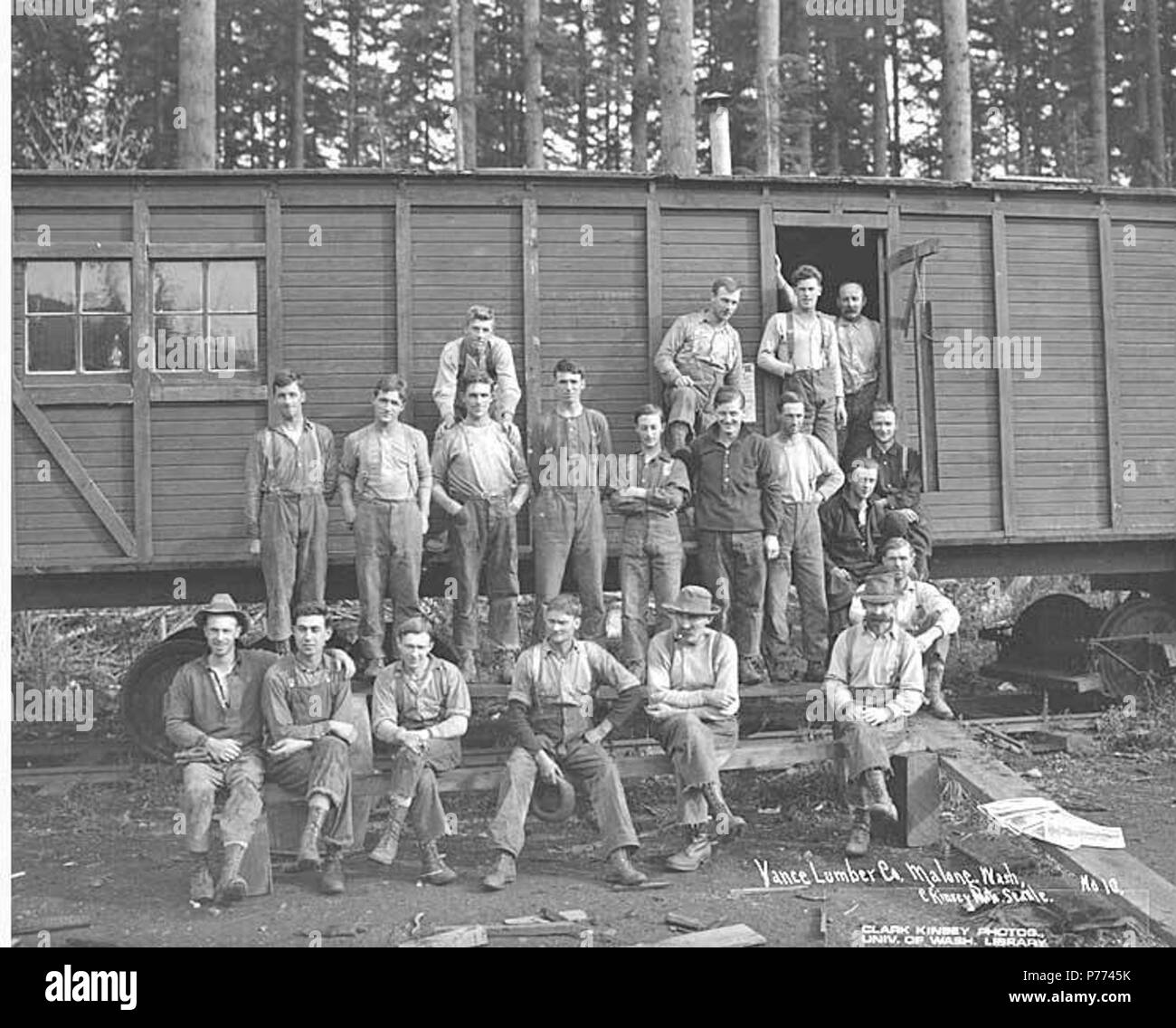 . English: Logging crew at railroad car mess hall, with Clark Kinsey ...