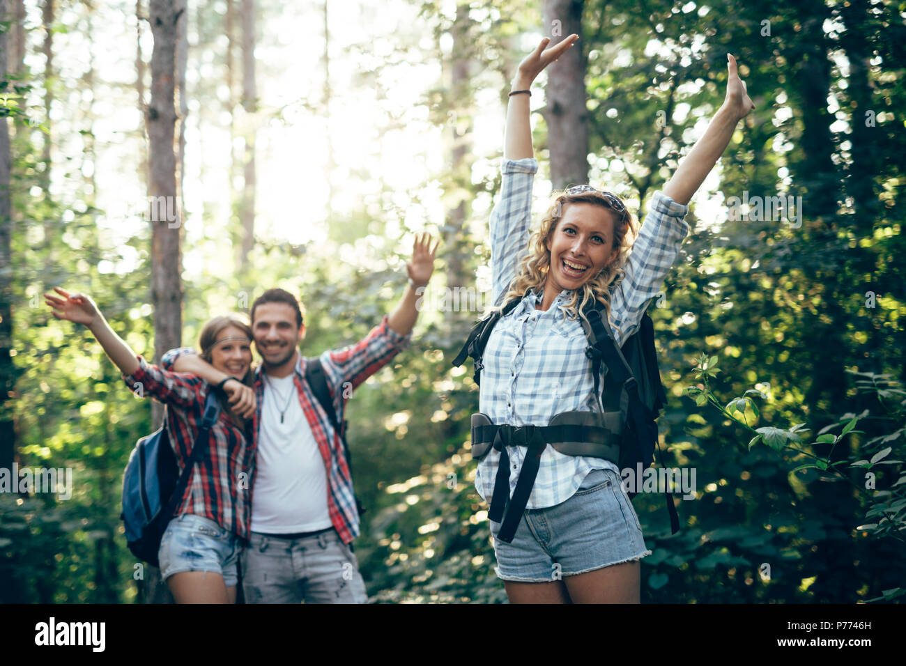 People trekking in forest Stock Photo - Alamy