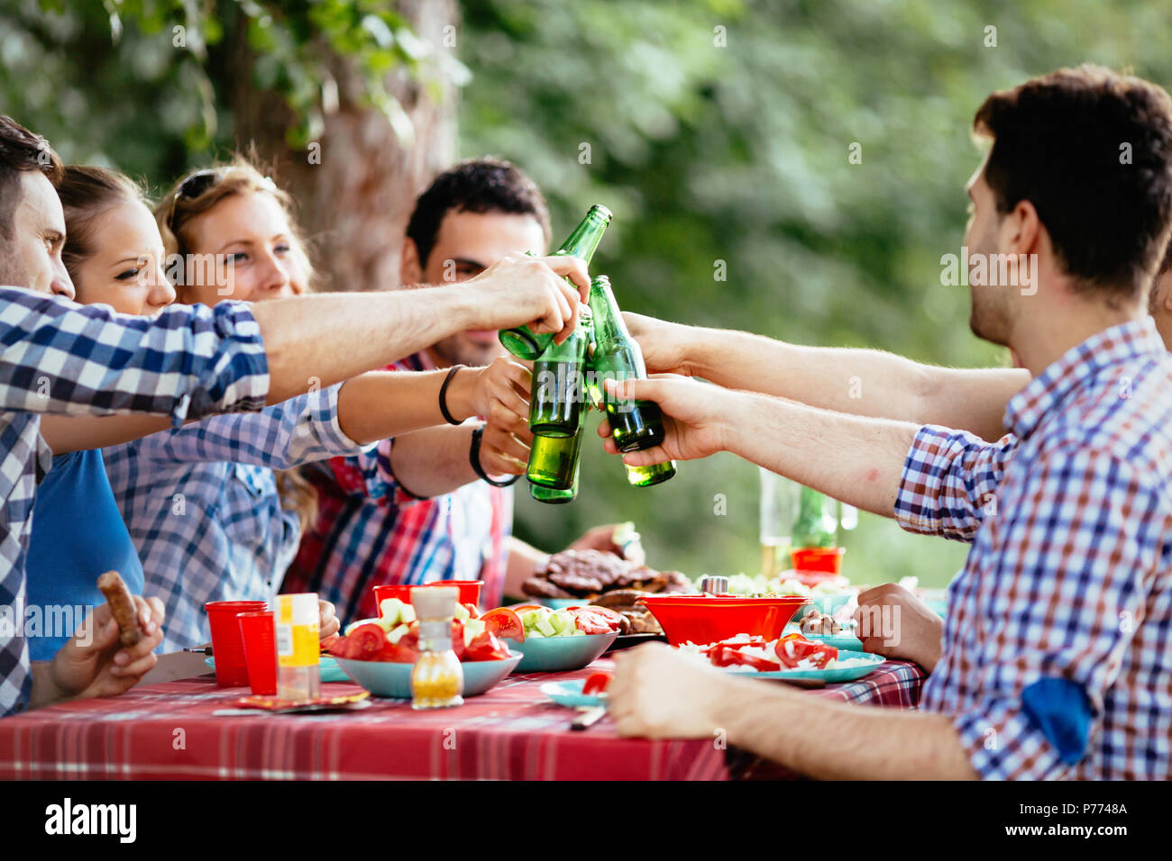 Group of happy people eating food outdoors Stock Photo - Alamy