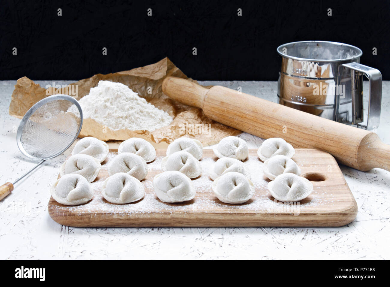 The process of making home-made dumplings. Raw homemade dumplings on a ...