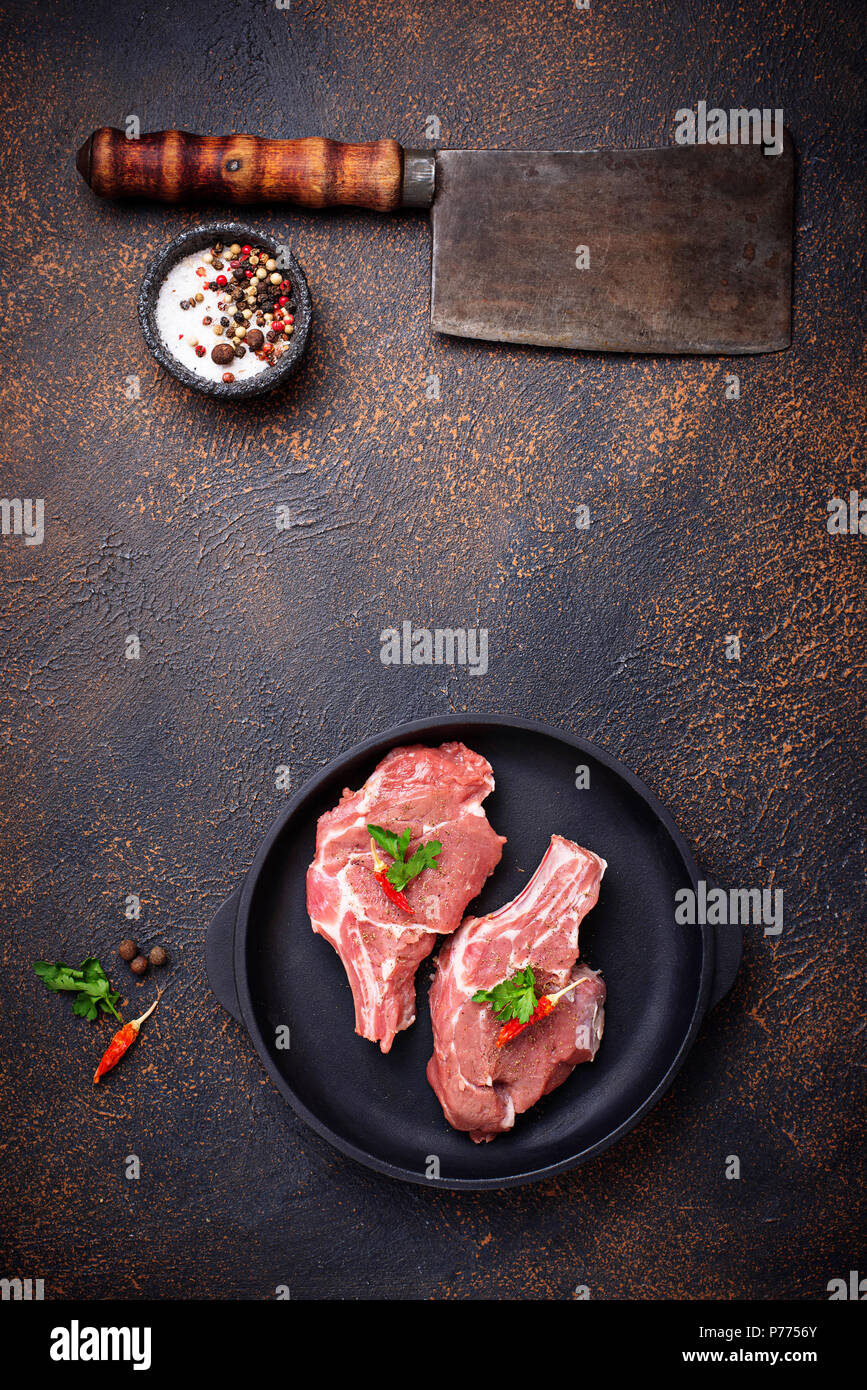 Raw meat and butchers knife. Top view Stock Photo - Alamy