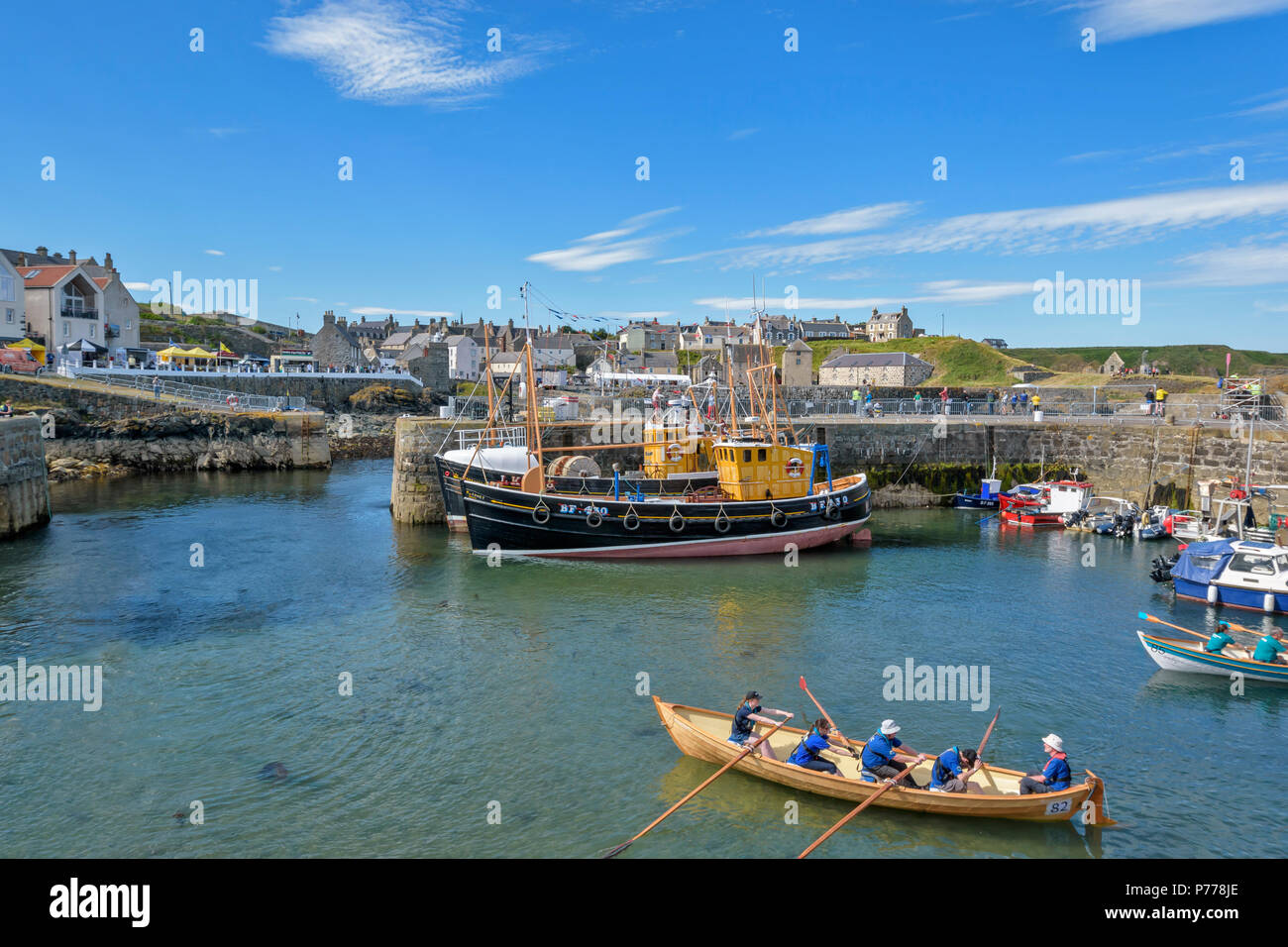 PORTSOY FESTIVAL ABERDEENSHIRE SCOTLAND BOAT RACES THE HARBOUR WITH ...