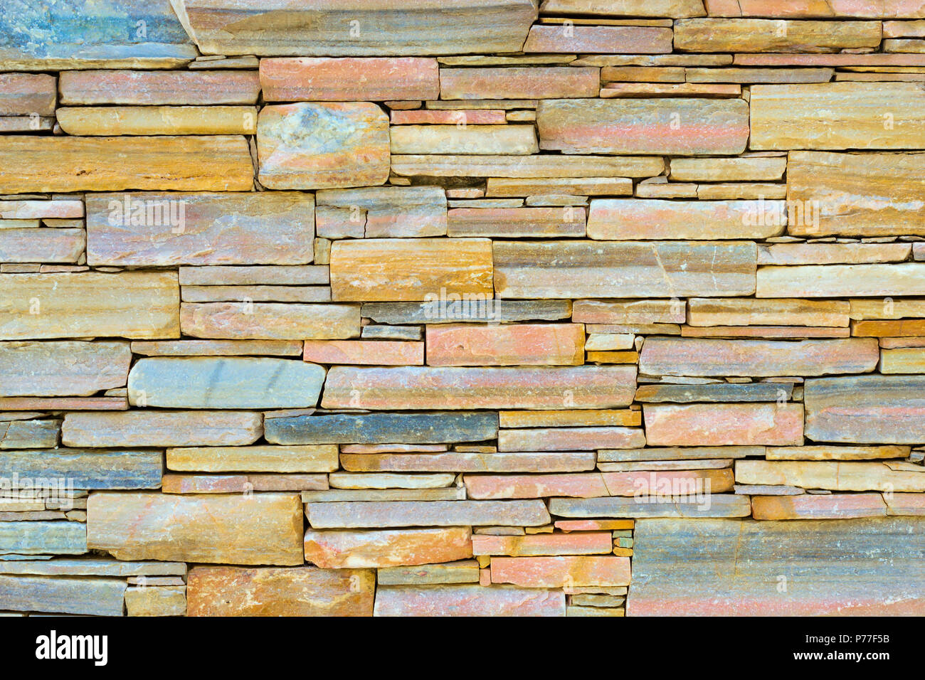 Decorative stone wall, pieces of rock bonded with cement. Cobble ...