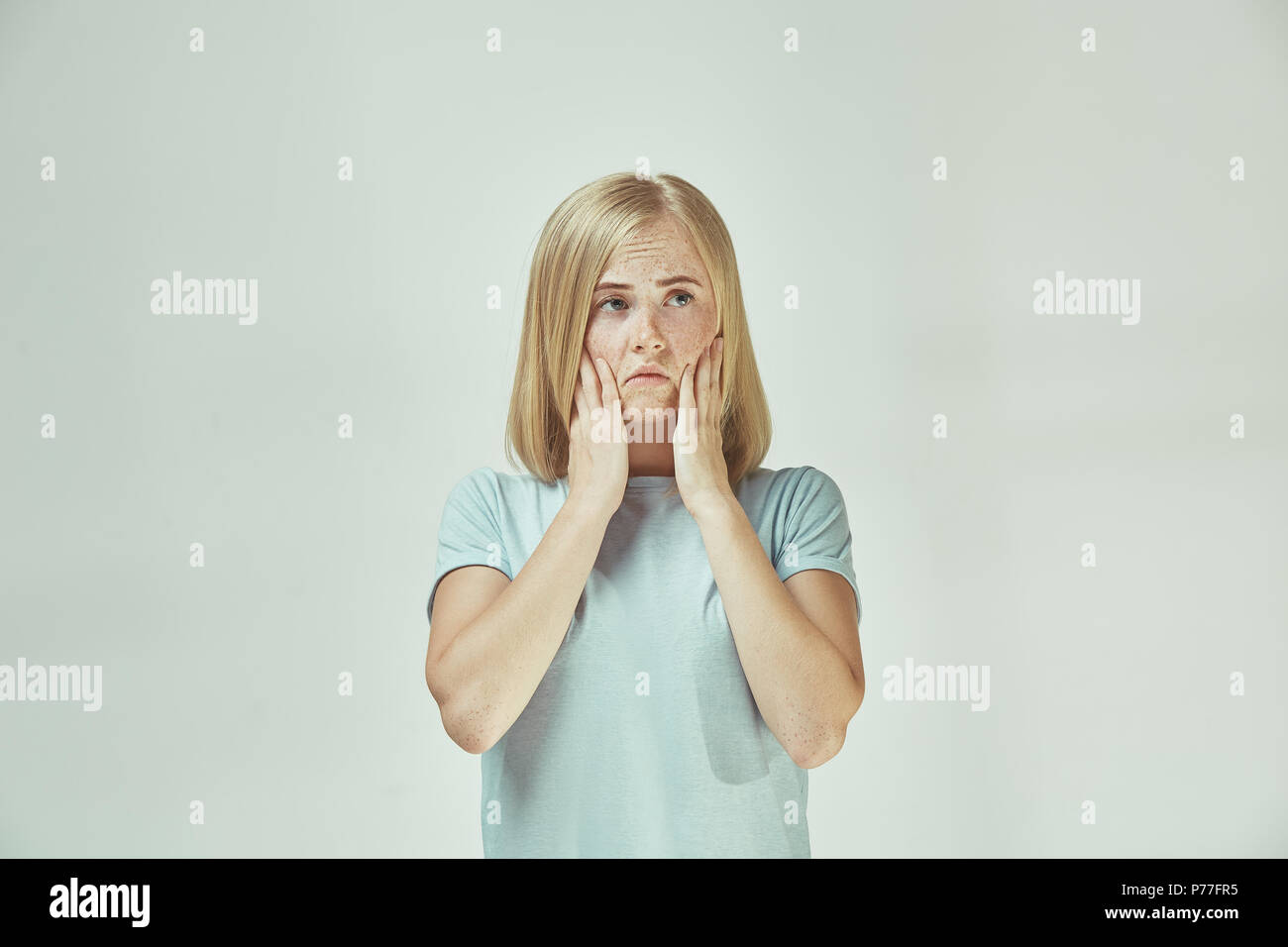 Beautiful woman looking suprised and bewildered Stock Photo - Alamy
