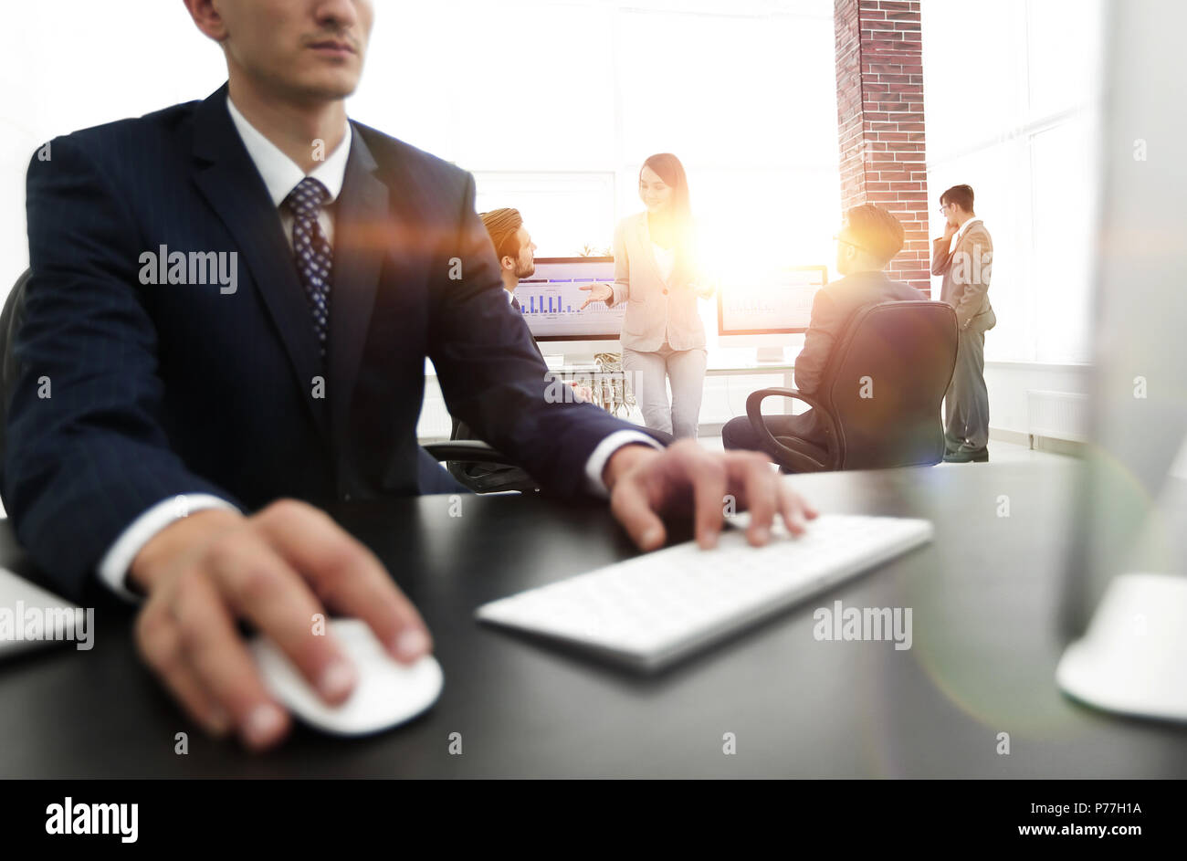 A male office worker browsing the computer for information Stock Photo ...